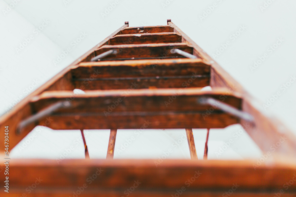 Foto de Front view of Antique wooden ladder in modern white brick ...
