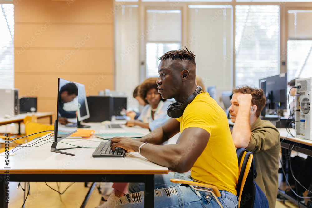 Black man working on computer at university Stock Photo | Adobe Stock