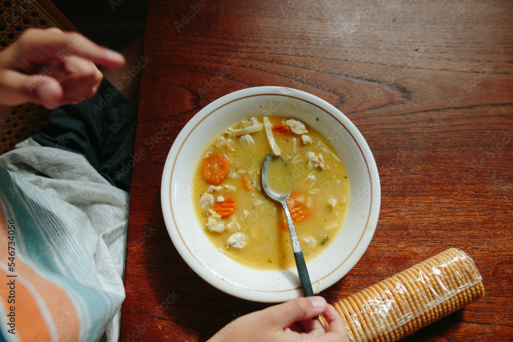 Tween boy eats chicken noodle soup Stock Photo | Adobe Stock