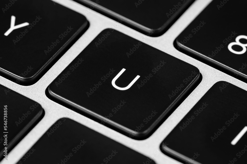 Closeup shot of a grey keyboard layout with black keys and white font ...