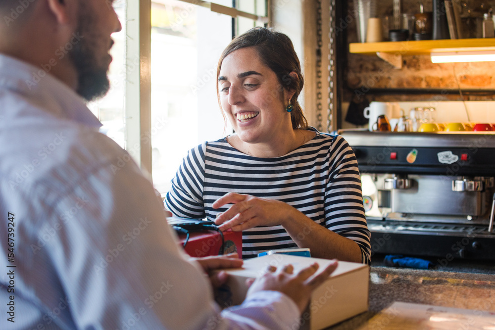 Female business owner interacting with client Stock Photo | Adobe Stock