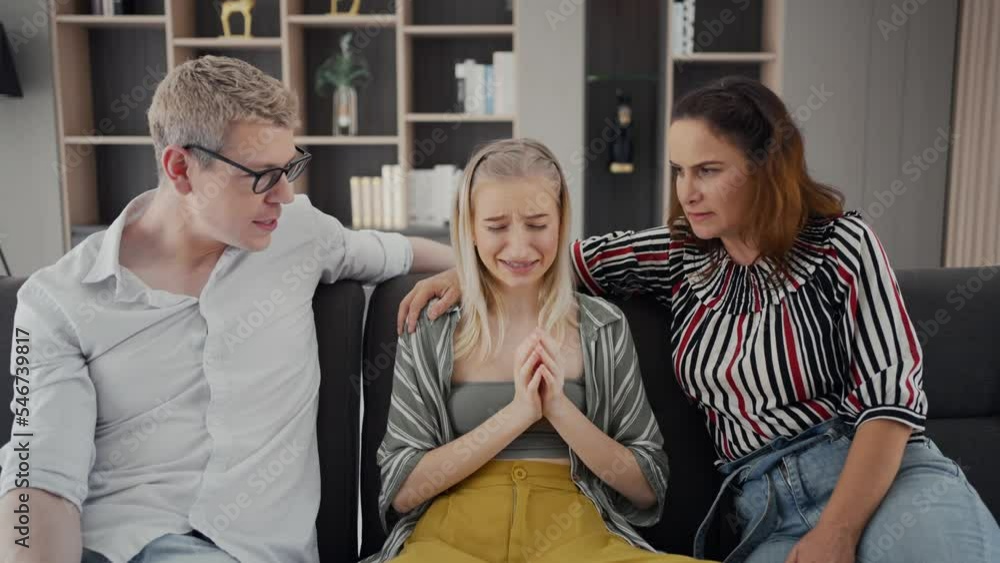 Worried mom and dad comforting depressed teen daughter bonding at home ...