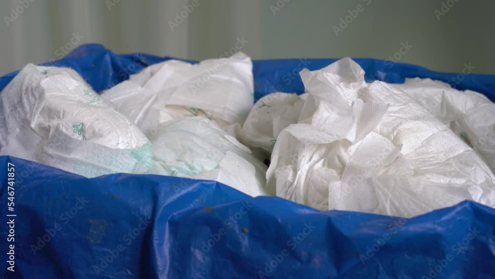 Dirty baby diapers in the trash. Disposing of used nappies. The problem ...