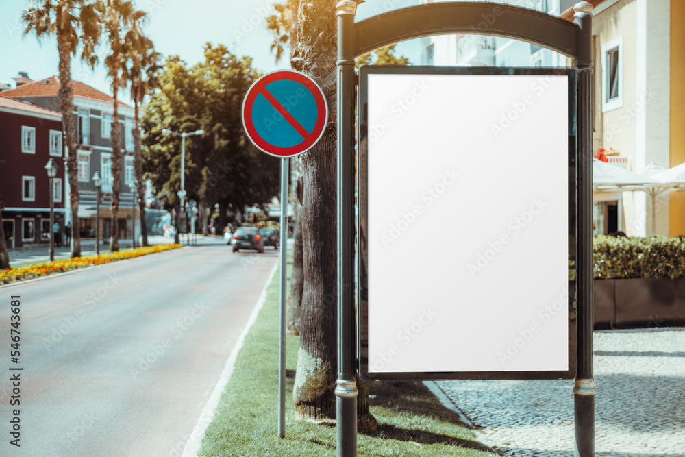 Blank ad billboard mockup next to the narrow city road and a road sign ...