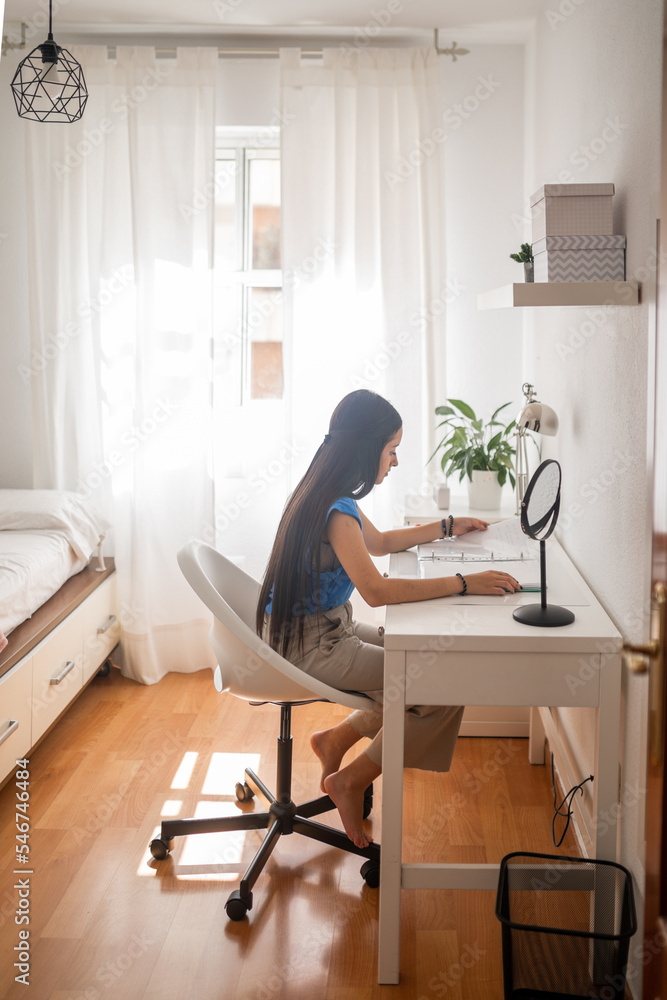 teenage girl studying at her bedroom desk Stock Photo | Adobe Stock