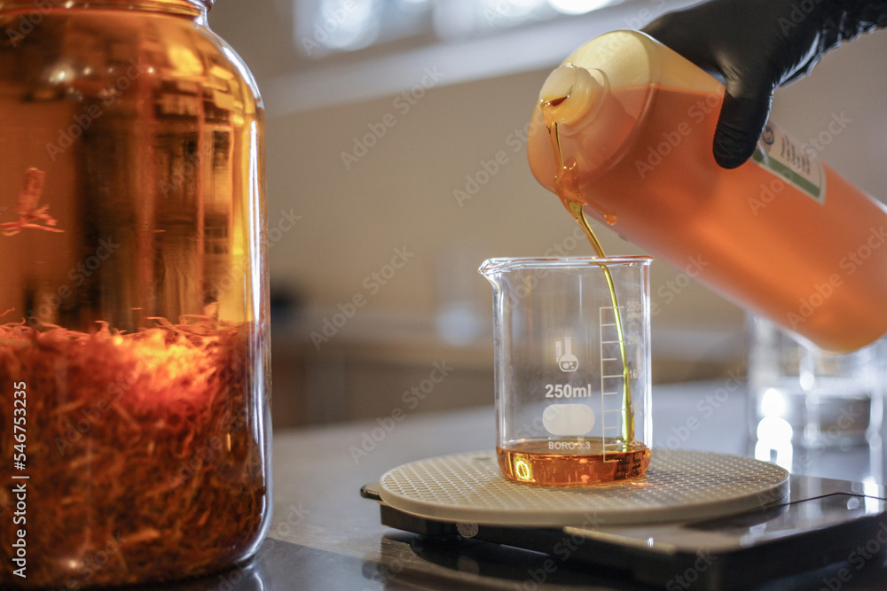 Anonymous Scientist Measuring Liquid in Beaker Stock Photo | Adobe Stock