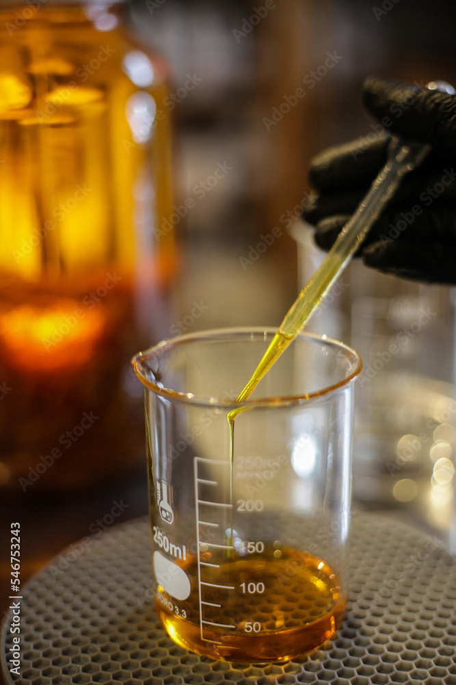 Anonymous Scientist Measuring Liquid in Beaker Stock Photo | Adobe Stock