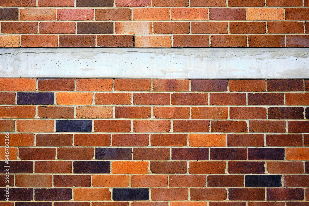 Red brick wall. Red and brown bricks laid around a concrete slab which ...