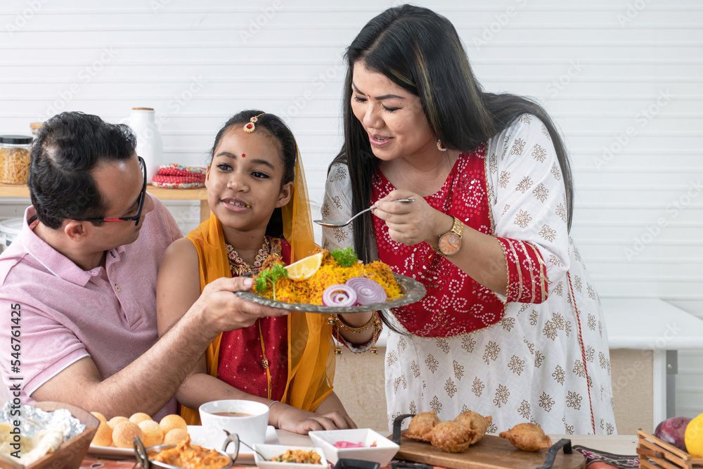Indian family with their dinner at modern kitchen at home, woman wears ...