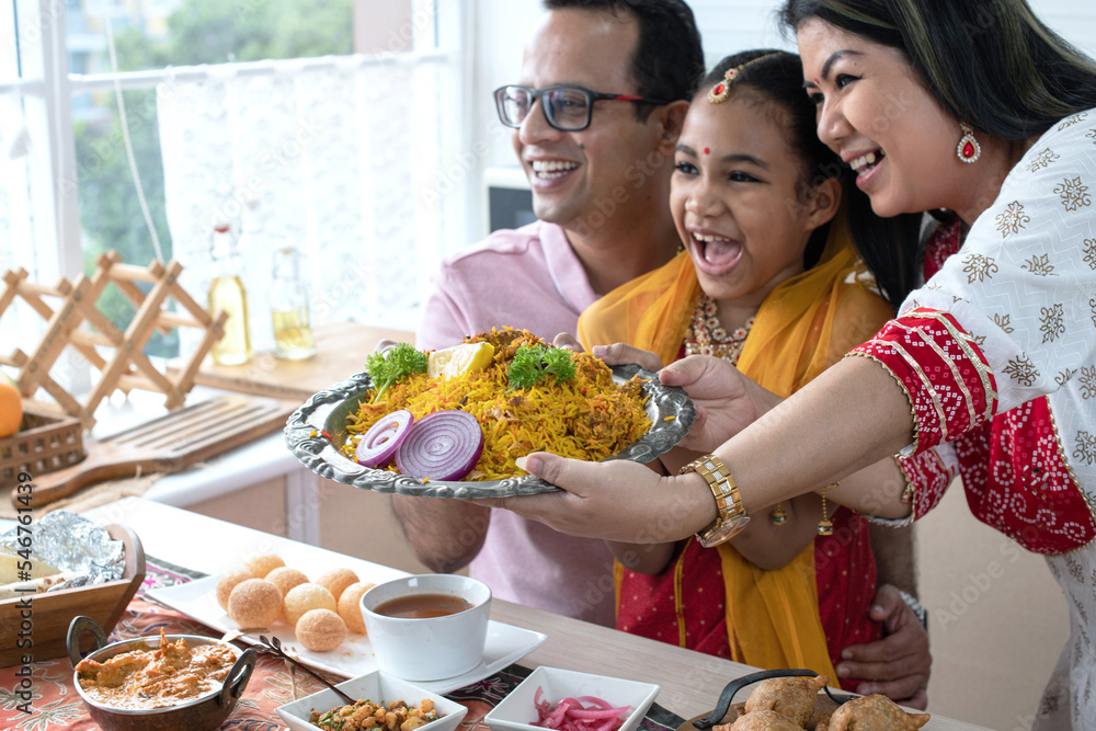Indian family with their dinner at modern kitchen at home, woman wears ...