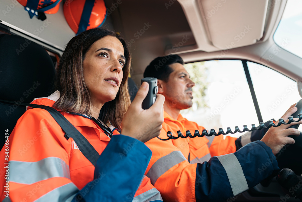 EMs Paramedic with Radio in Ambulance Stock Photo | Adobe Stock