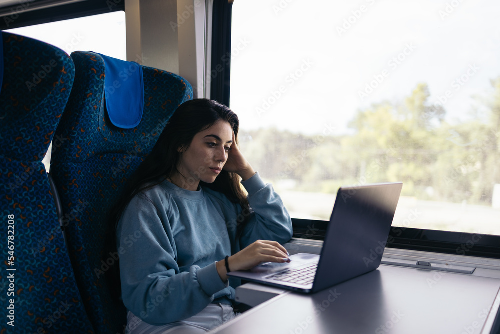 Young woman working and studying with laptop from the train Stock Photo ...