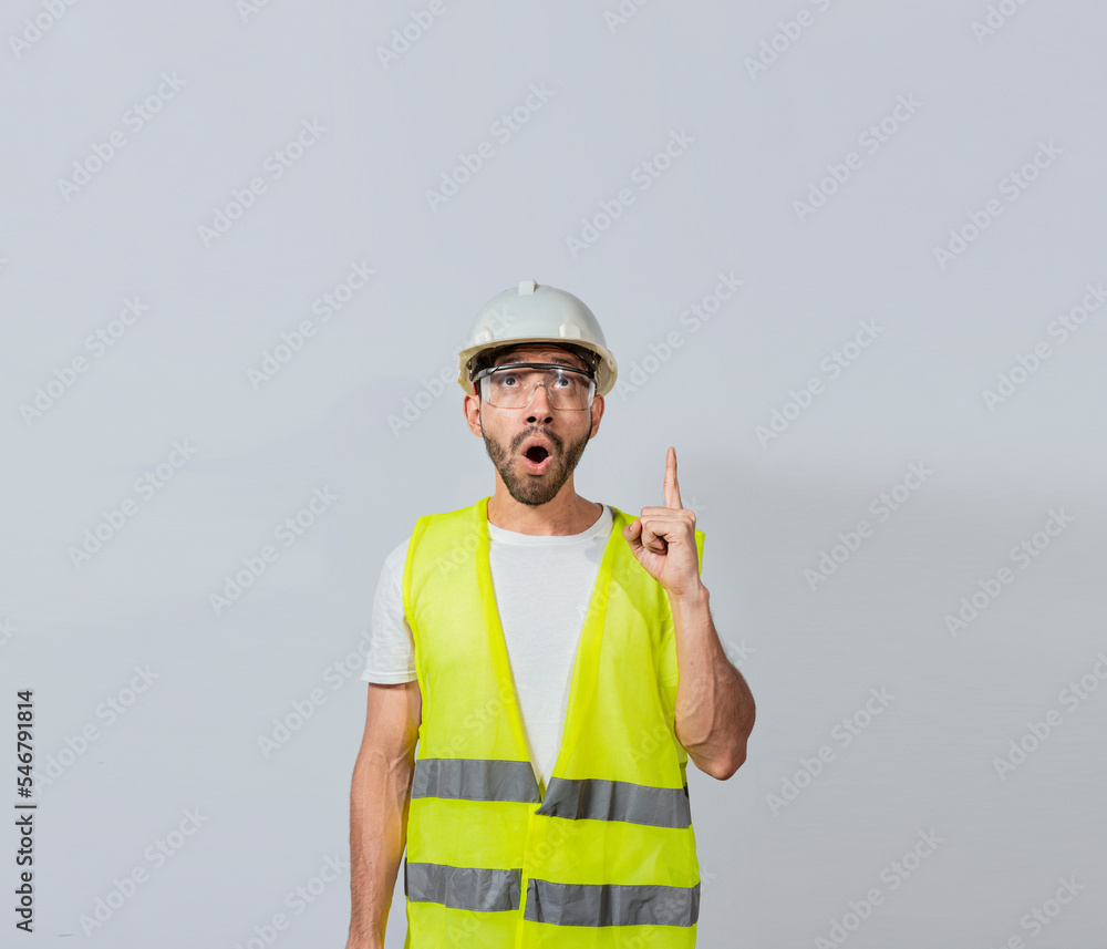 Amazed engineer man pointing up, Surprised young architect pointing up ...