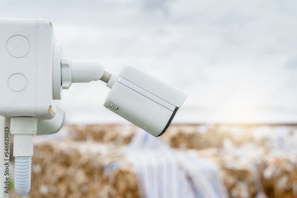 Side view of white CCTV security camera video system for safety at a ...