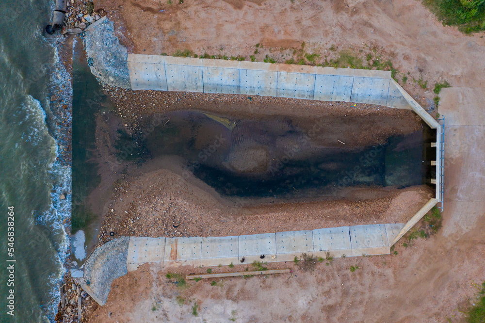 Sewer tunnel in an industrial factory into the sea. Industrial waste ...