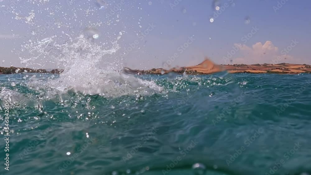 Half underwater back view scene of woman diving in clear blue water ...