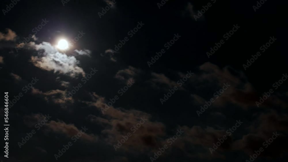 Hyperlapse the Moon moves smoothly across the night sky. Clouds of the ...