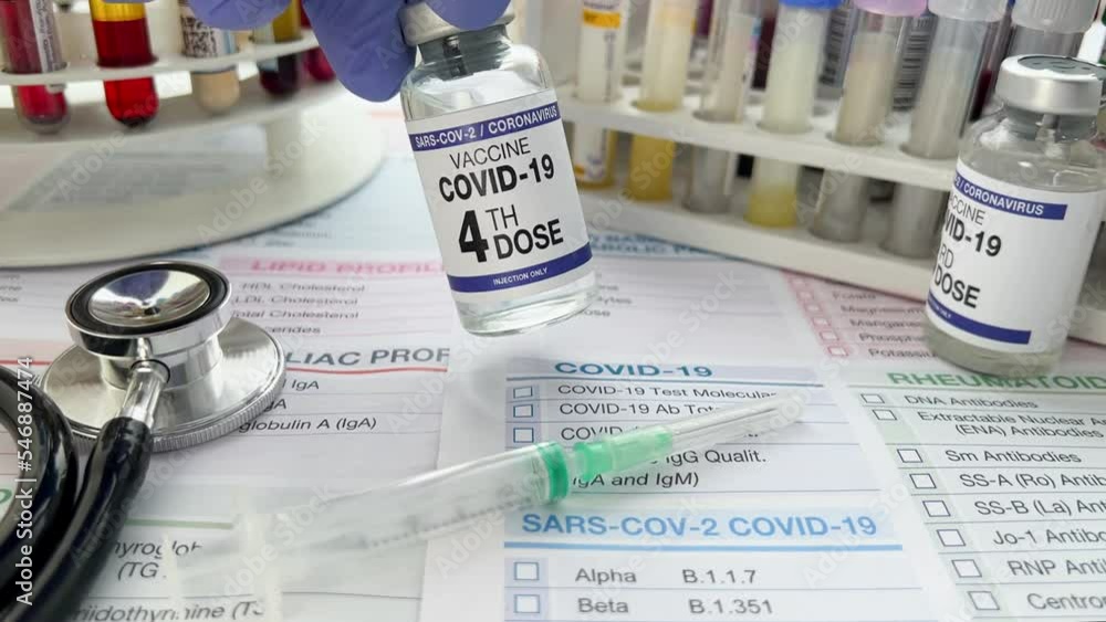 Technican holding Coronavirus vaccine vial fourth dose for new variants ...