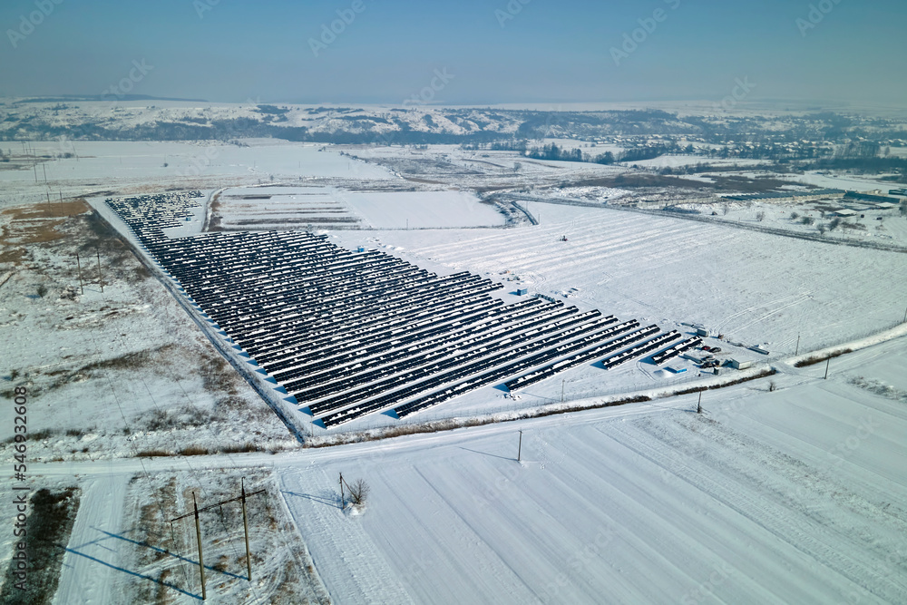 Aerial view of snow melting from covered solar photovoltaic panels at ...