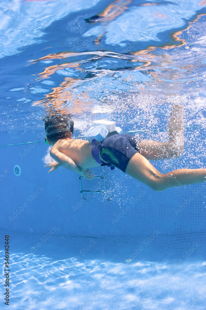 boy swimming in pool Stock Photo | Adobe Stock