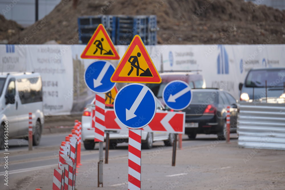 Roadworks warning traffic signs of construction work on city street and ...