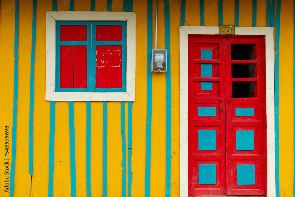 dors and windos decorete the wooden walls of a characteristic little ...