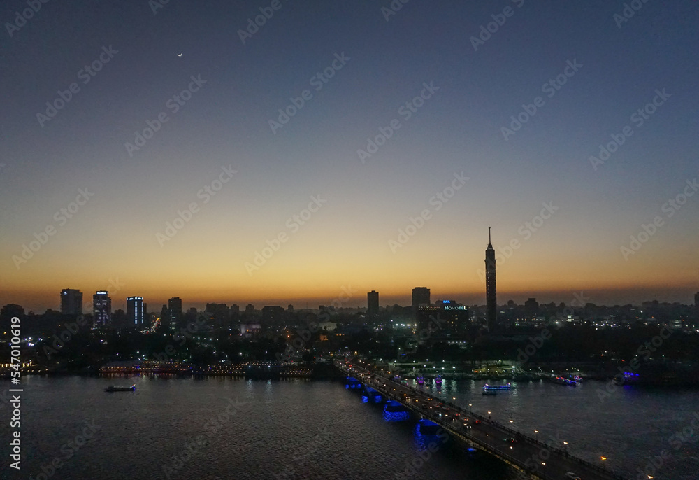 Cairo, Egypt: Cairo Tower and the Qasr el Nile Bridge at sunset. On ...