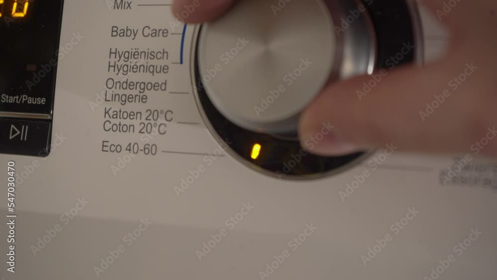 Narrow focus close-up: Dutch laundry washer dial turned to eco setting ...