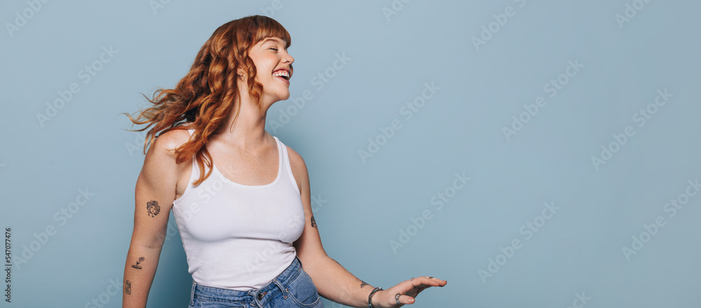 Woman with ginger hair dancing and having fun in a studio Stock Photo ...