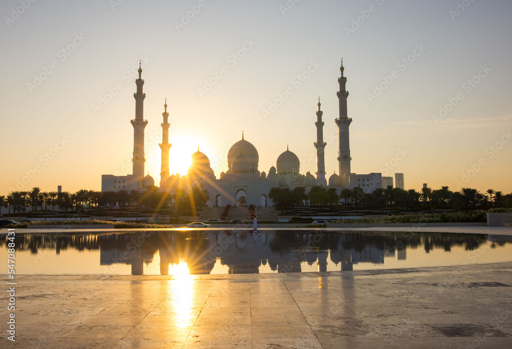 Tourists visit the Sheikh Zayed Grand Mosque. Night time view opposite ...