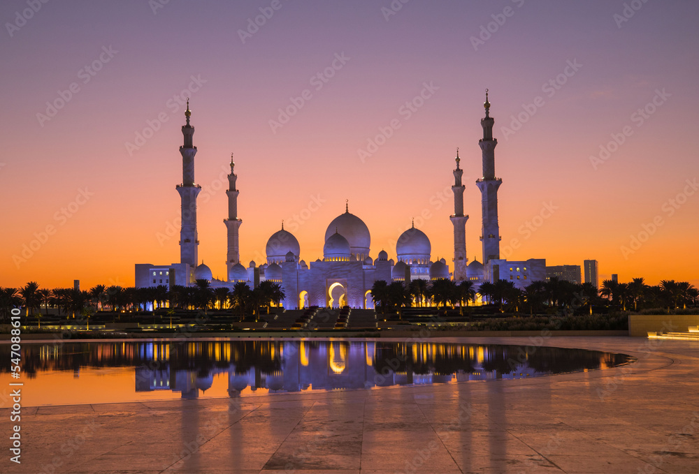 Tourists visit the Sheikh Zayed Grand Mosque. Night time view opposite ...