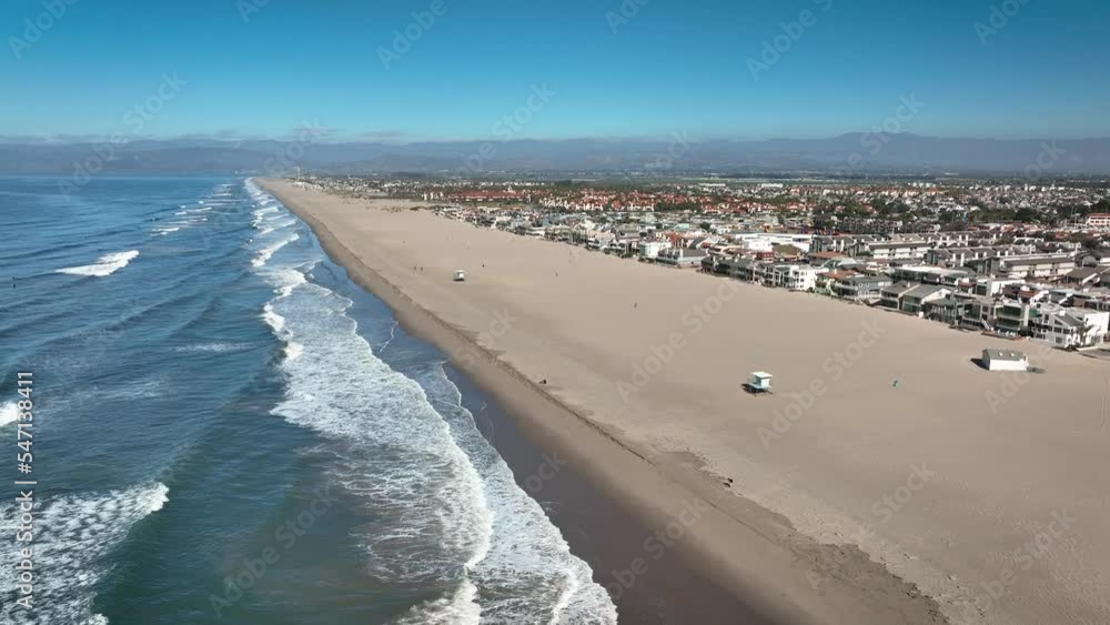Aerial calm sandy Hollywood beach with foamy waves against a clear blue ...