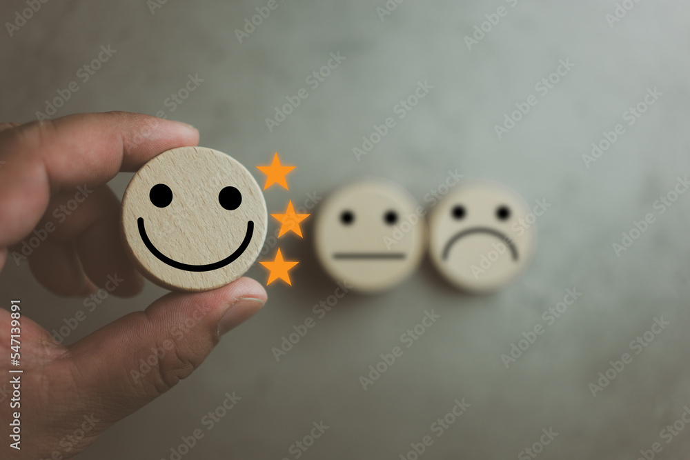 Customer satisfaction survey concept. Customer selects wooden cube with ...