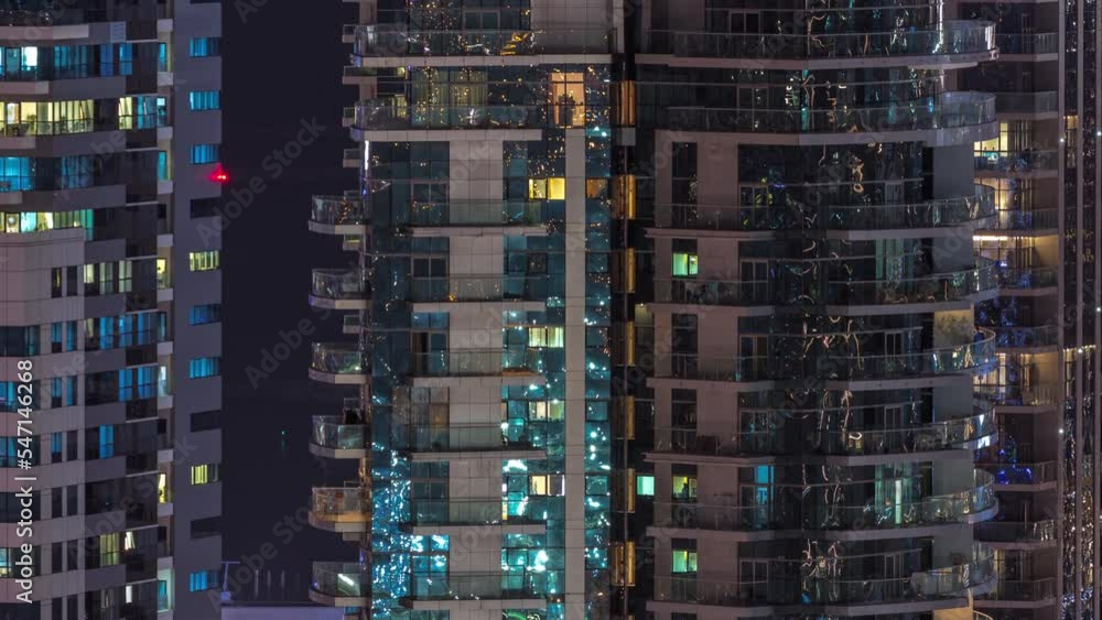 Windows in high-rise building exterior in the late evening with glowing ...