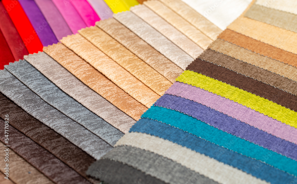 Fabric swatches in different colors are stacked for selection. A ...