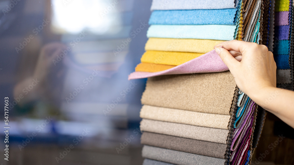 Fabric swatches in different colors are stacked for selection. The ...