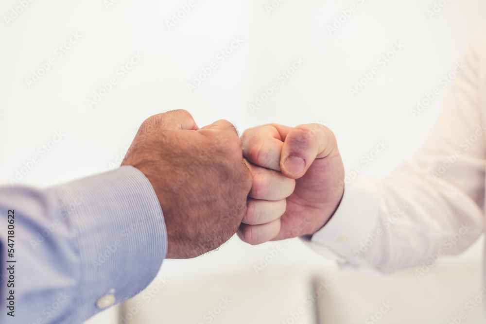 Shot of two unrecognizable businesspeople giving a fist bump outside ...
