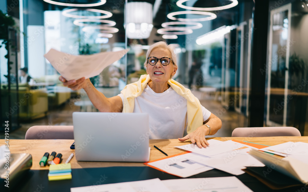 Angry aged female boss yelling at work Stock Photo | Adobe Stock