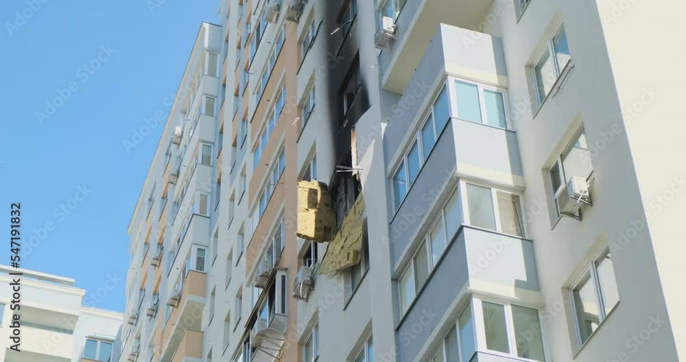 Window outside is black from the soot of the fire. Low angle, side view ...