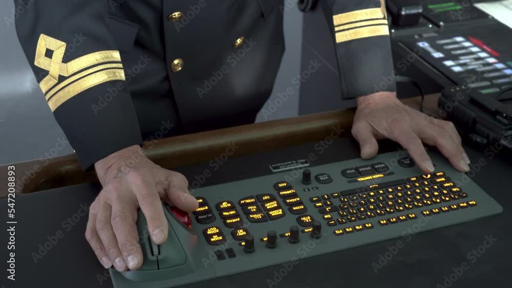 Navigation bridge on vessel. Ship's control panel. Hands of officer ...