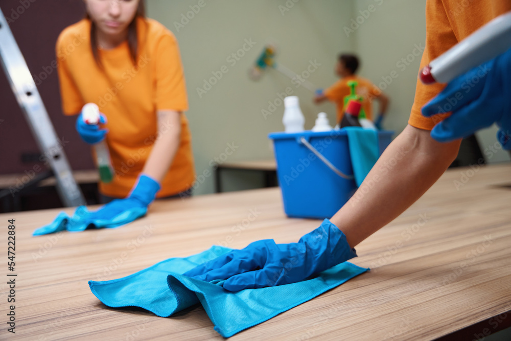 Committed janitor cleaning and sanitizing the table surface Stock Photo ...