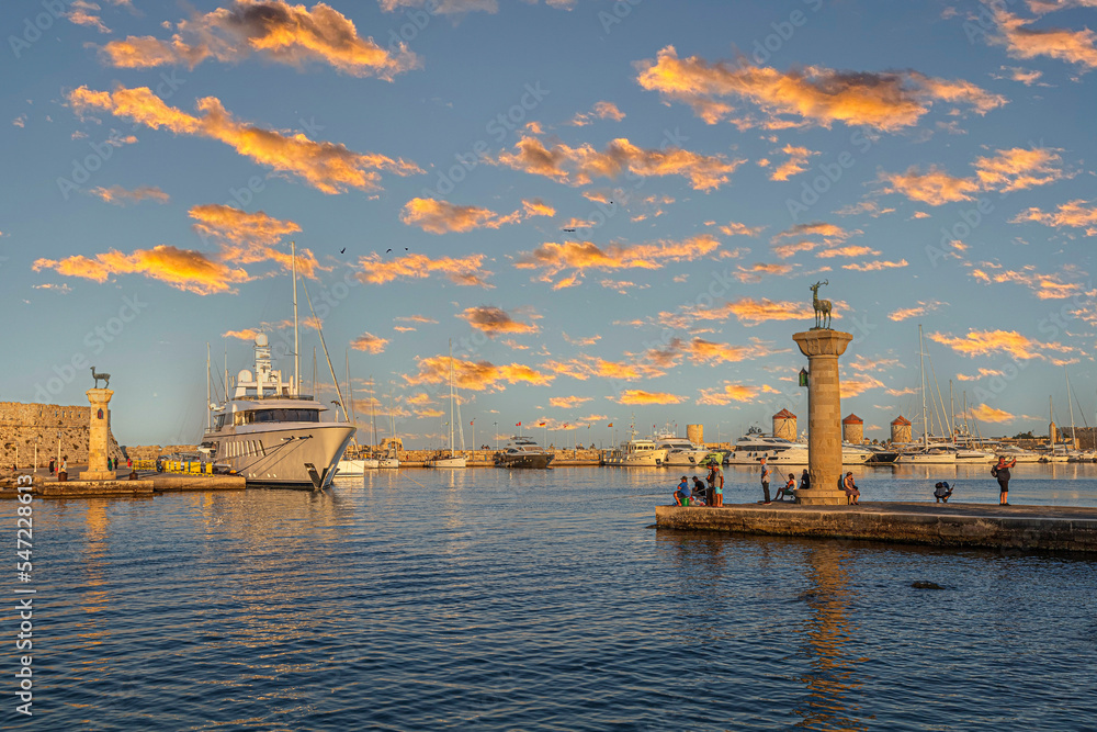 Afternoon view with the Mandraki Marina Port, symbolic deer statues ...