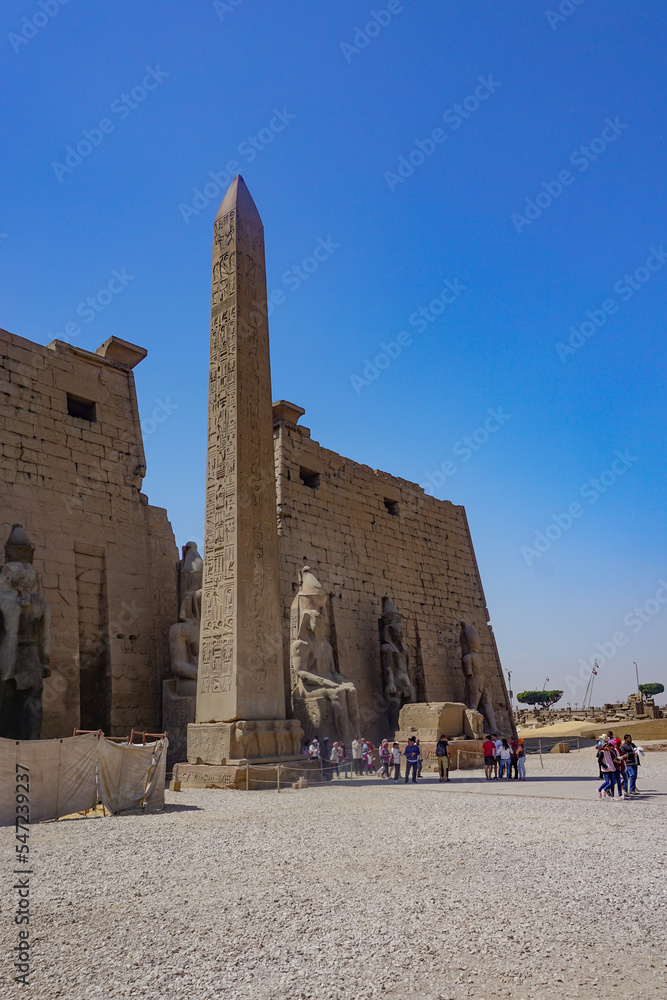 Luxor, Egypt: Groups of tourists at the entrance to the first pylon of ...