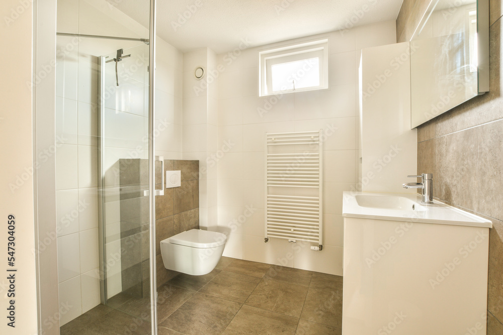 Glass partition between shower tap and wall hung toilet in modern ...