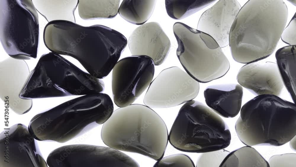 Stockvideo Obsidian heap jewel stones texture on white light background ...