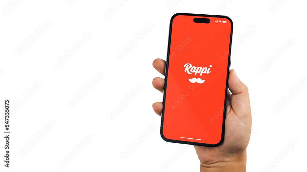 Boy holding a smartphone iPhone 14 Pro with Rappi delivery app on the screen. White background ...