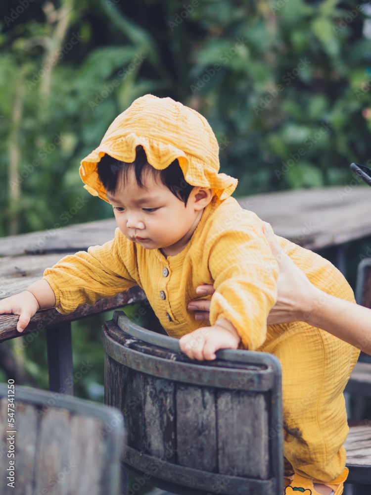 Asian baby of Thai nationality on vintage chair at De mala Cafe, Thung ...