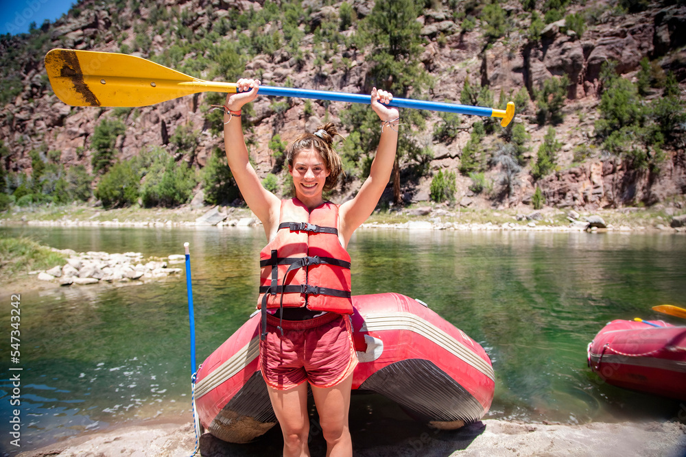 Excited Young woman going river rafting down the Green River while on ...
