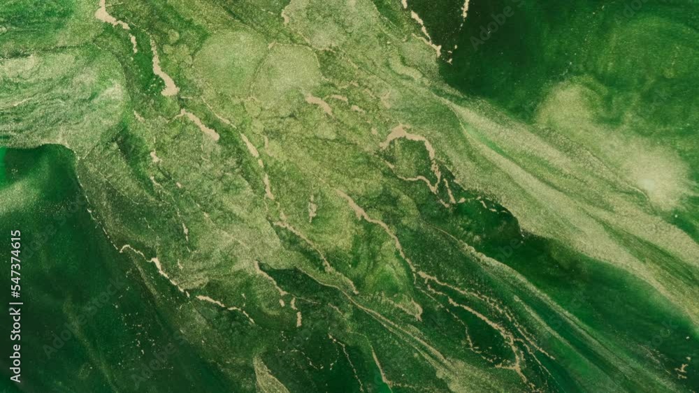 Green color wet abstract pattern. Green gold paint slow motion backdrop ...