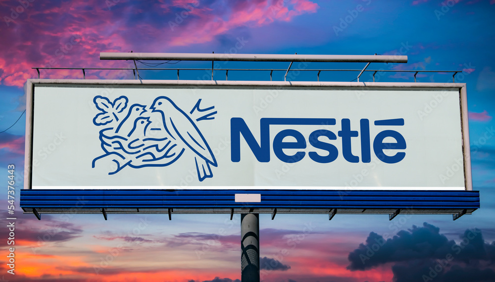 Advertisement billboard displaying logo of Nestle Stock Photo | Adobe Stock